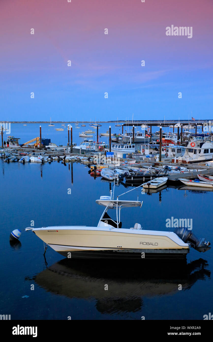 Recreational boats docking along MacMillan Pier after sunset ...