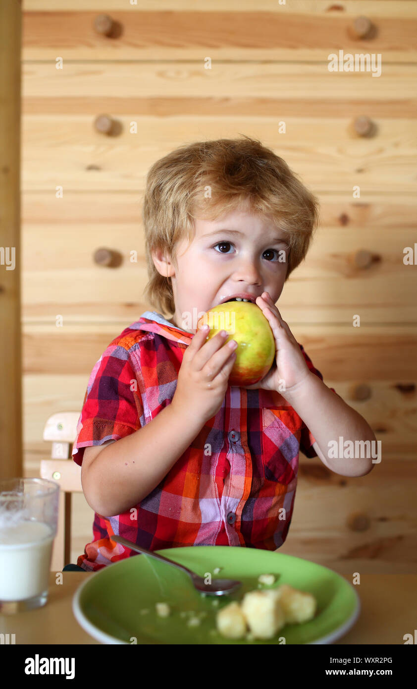 Small boy child eat banana and drink milk. Kid or blonde happy boy ...
