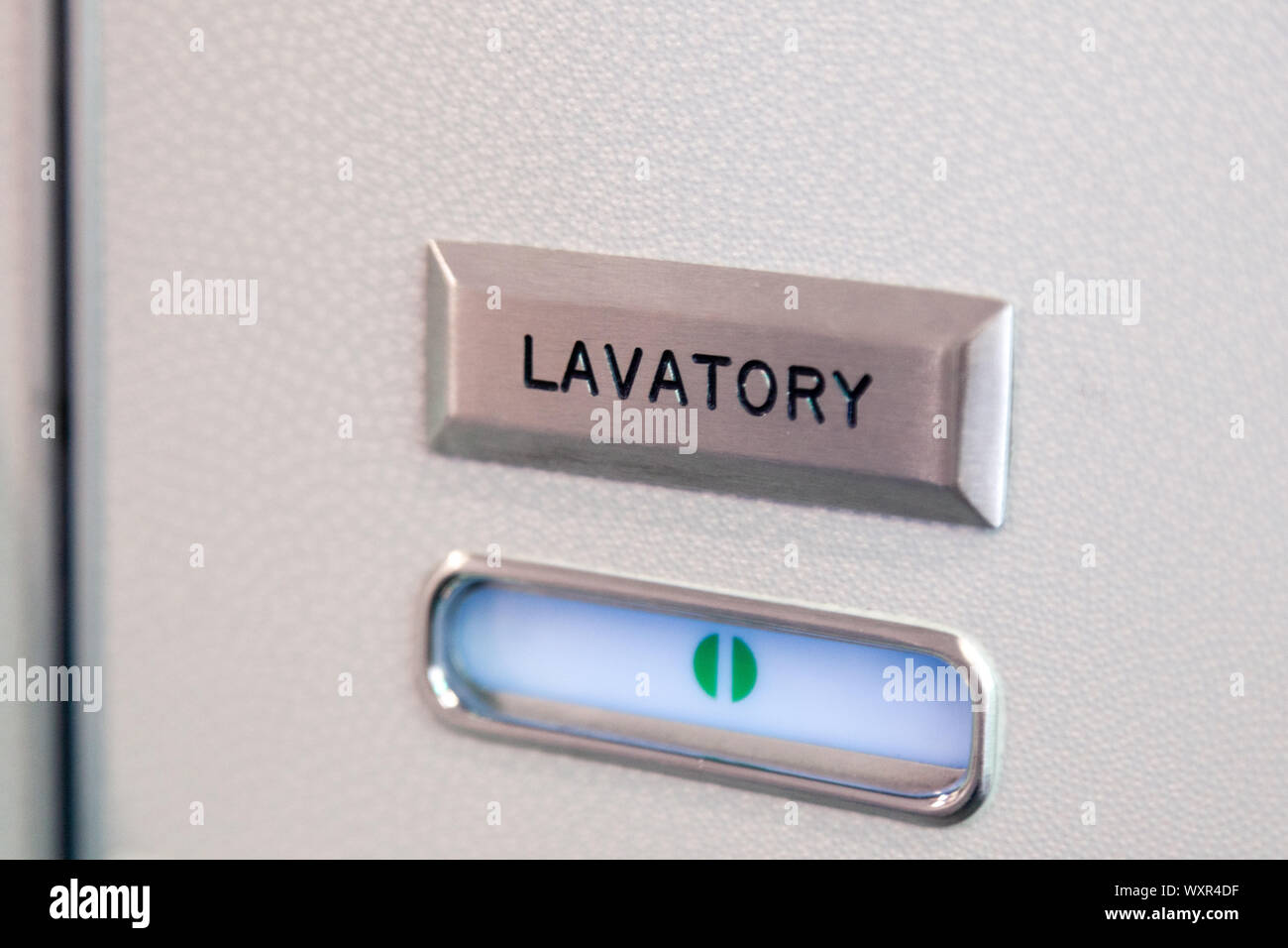 Vacant green sign, vacant symbol on an airplane lavatory door. Raised ...
