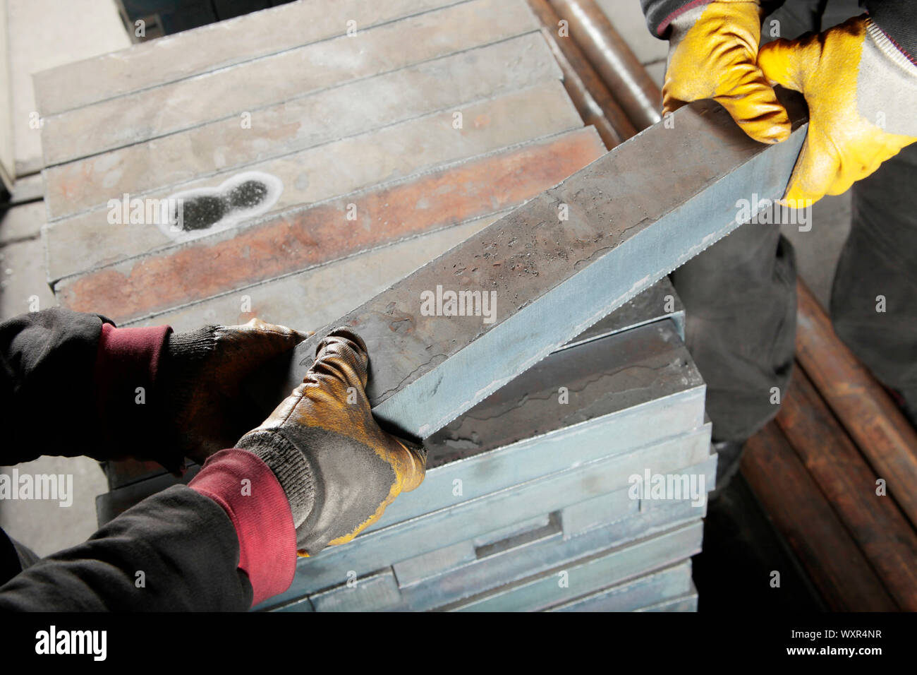 workers and heavy metal blocks Stock Photo - Alamy