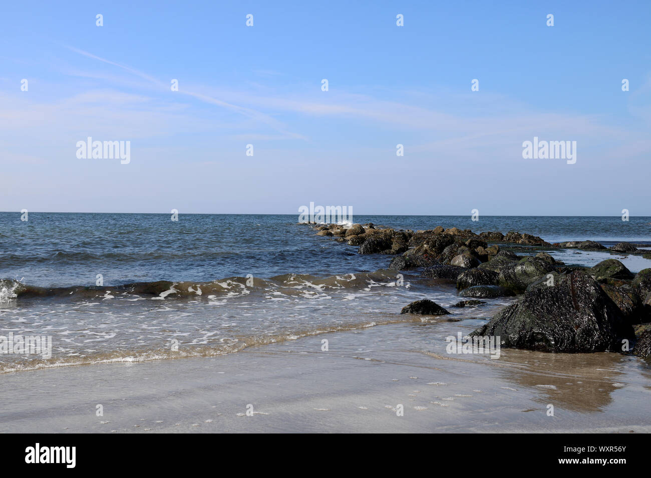 Rocky outcrop sand and sea at a coastal beach Stock Photo - Alamy