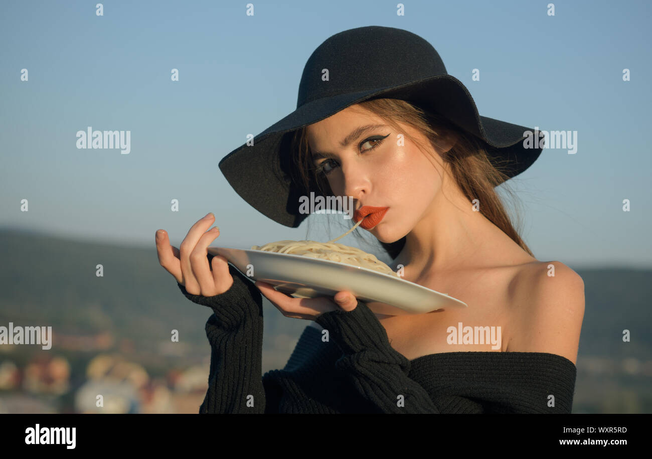 food and health. food of italian macaroni in hands of elegant woman in ...