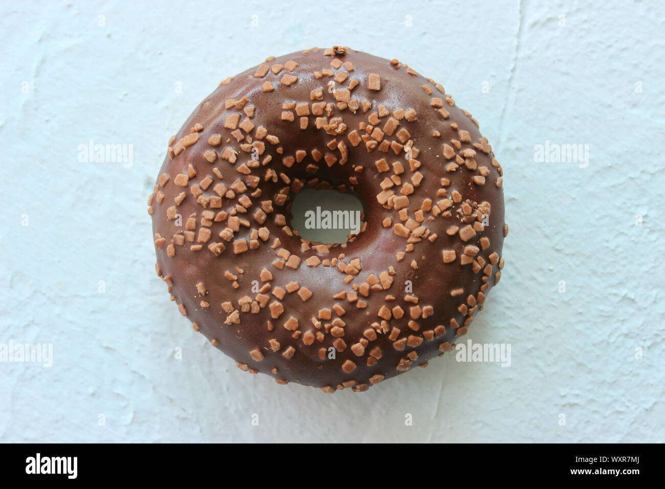 Doughnut in chocolate icing Doughnut in chocolate icing white textured ...