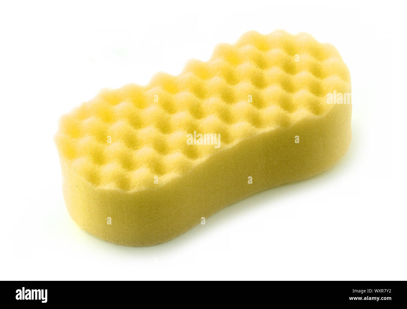 Yellow sponge for washing dishes on a white background. The sponge has ...