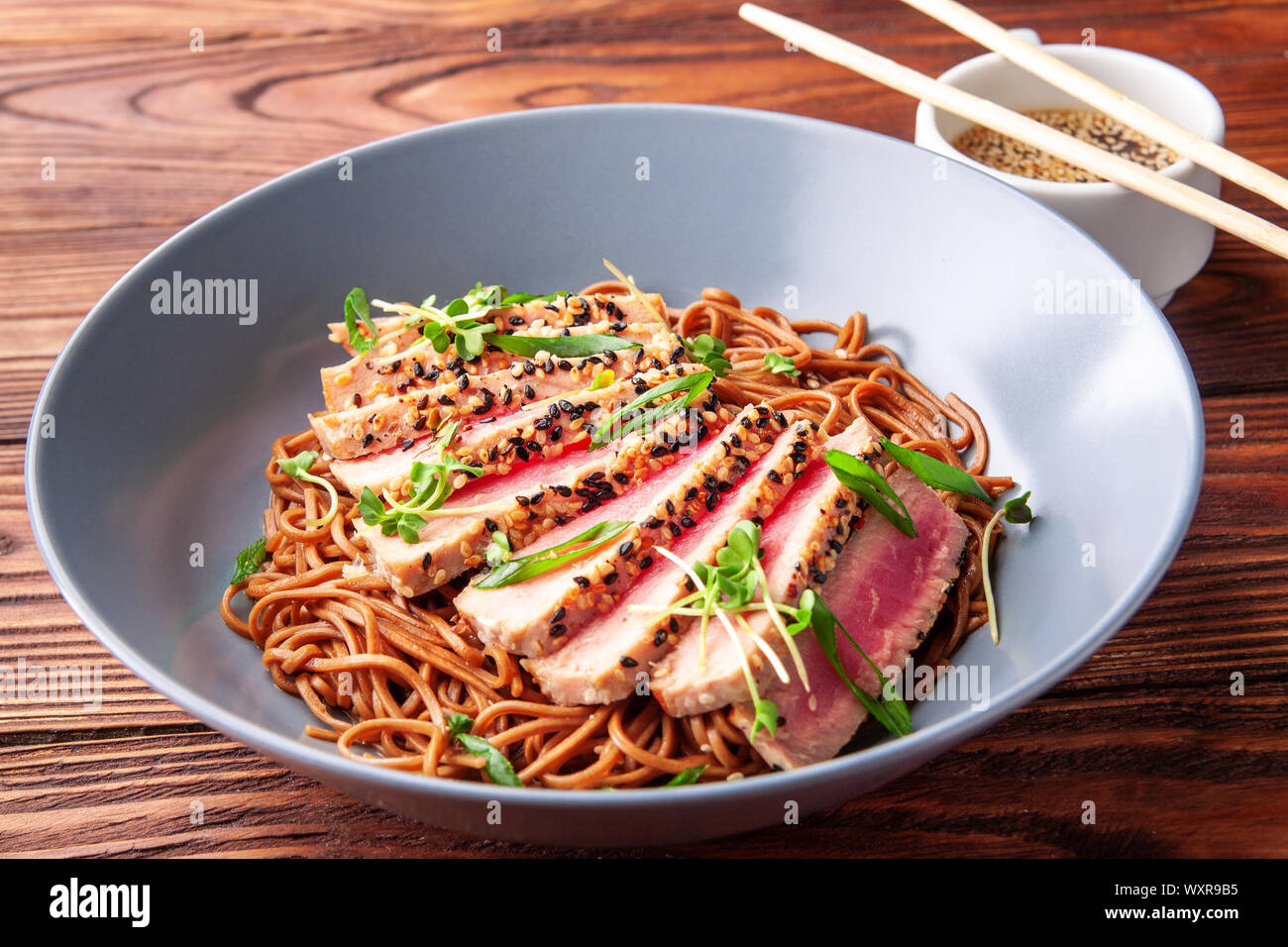 Japanese buckwheat soba noodles with sliced tuna with sesame on dark ...