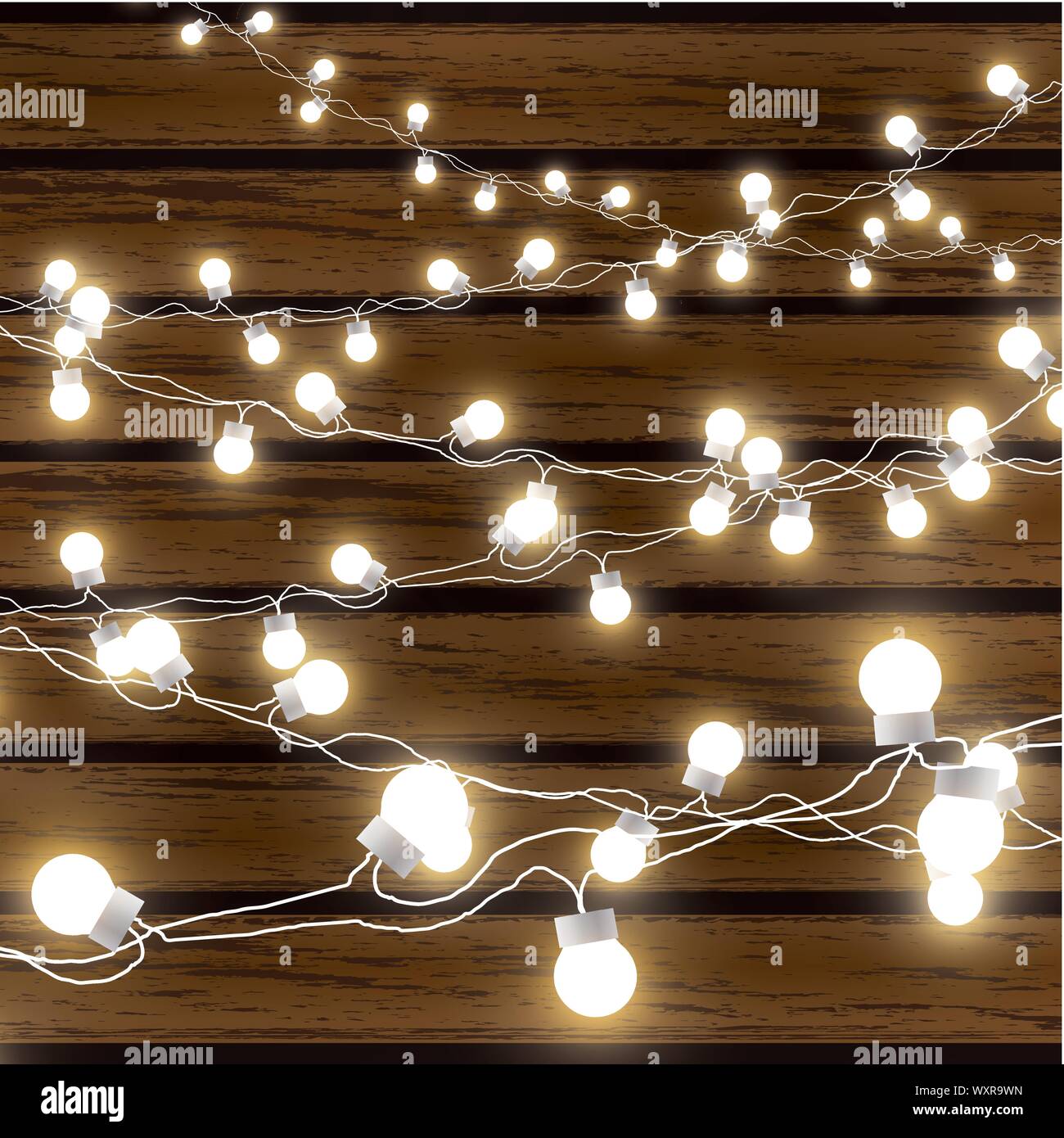 Christmas lights isolated on dark wooden background. Glow garland ...