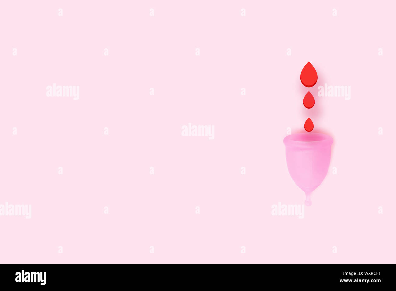 Pink menstrual cup on pink background. Flat lay, top view. copy space ...