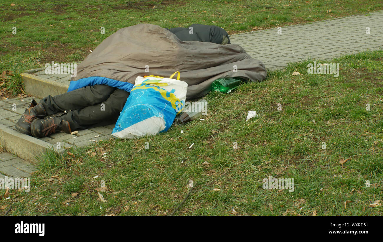 Authentic emotion homeless man senior sleep in sleeping bag on street ...