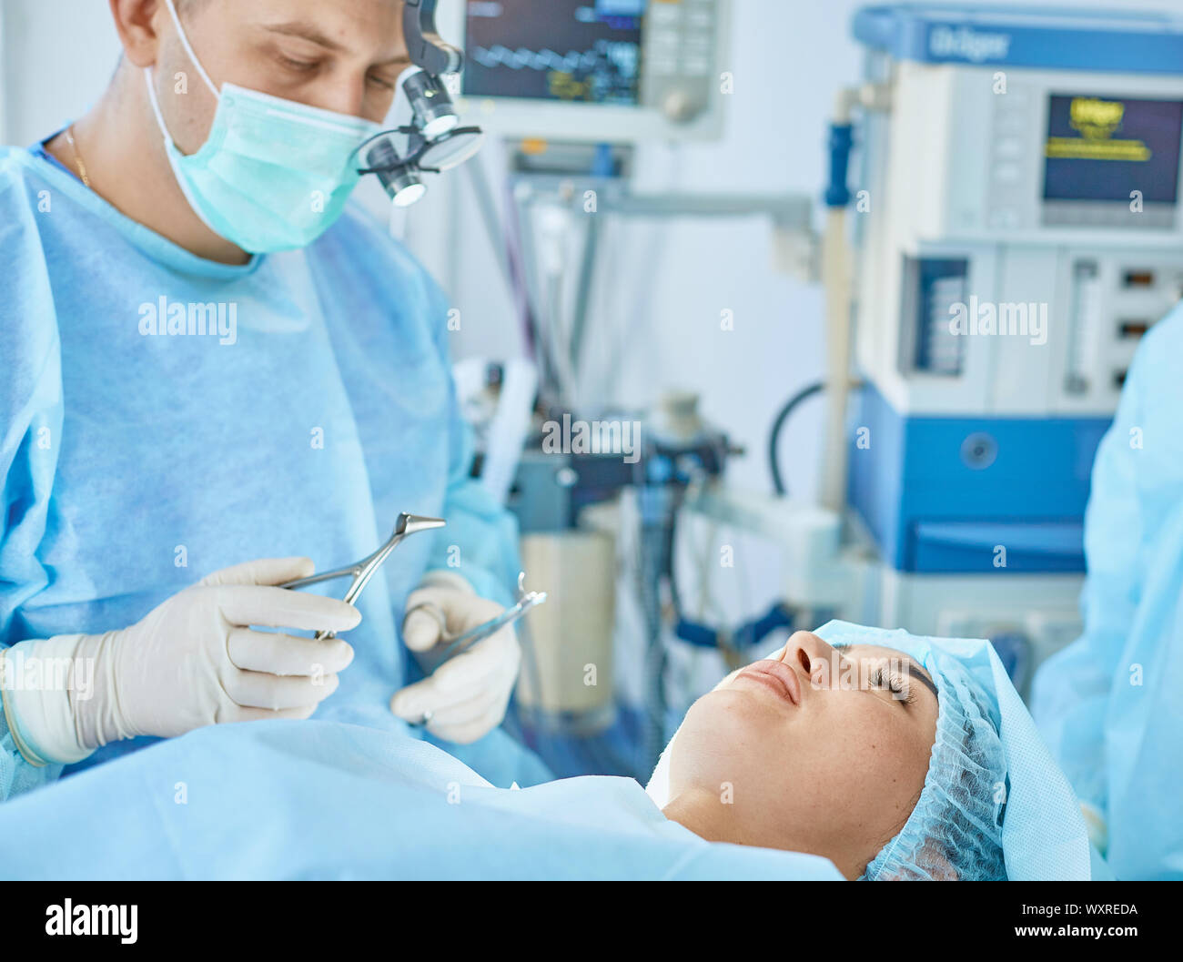 Several doctors surrounding patient on operation table during their ...