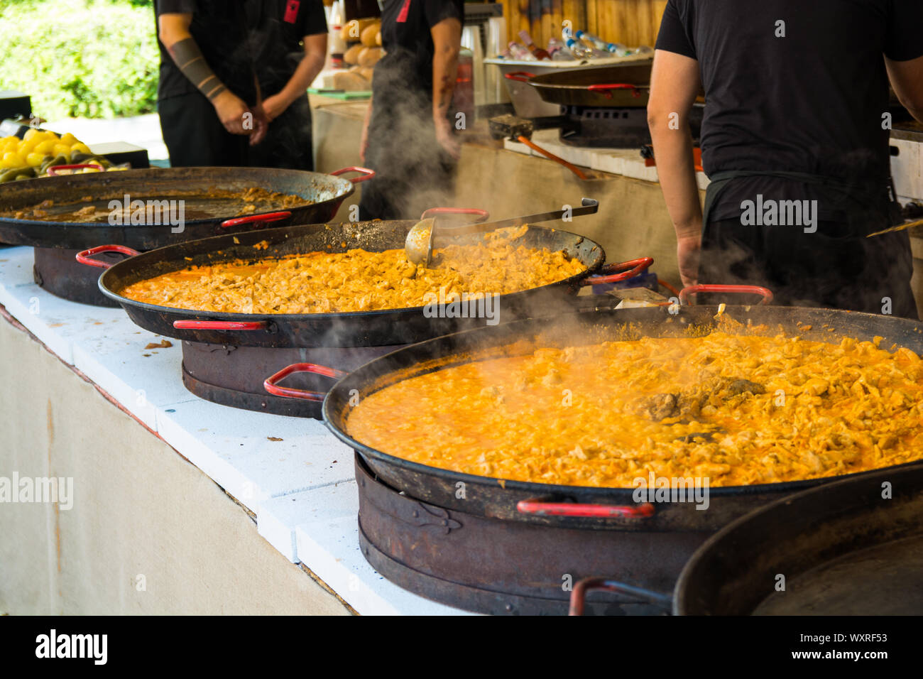 Paella served from paella dishes on a street food festival Stock Photo ...