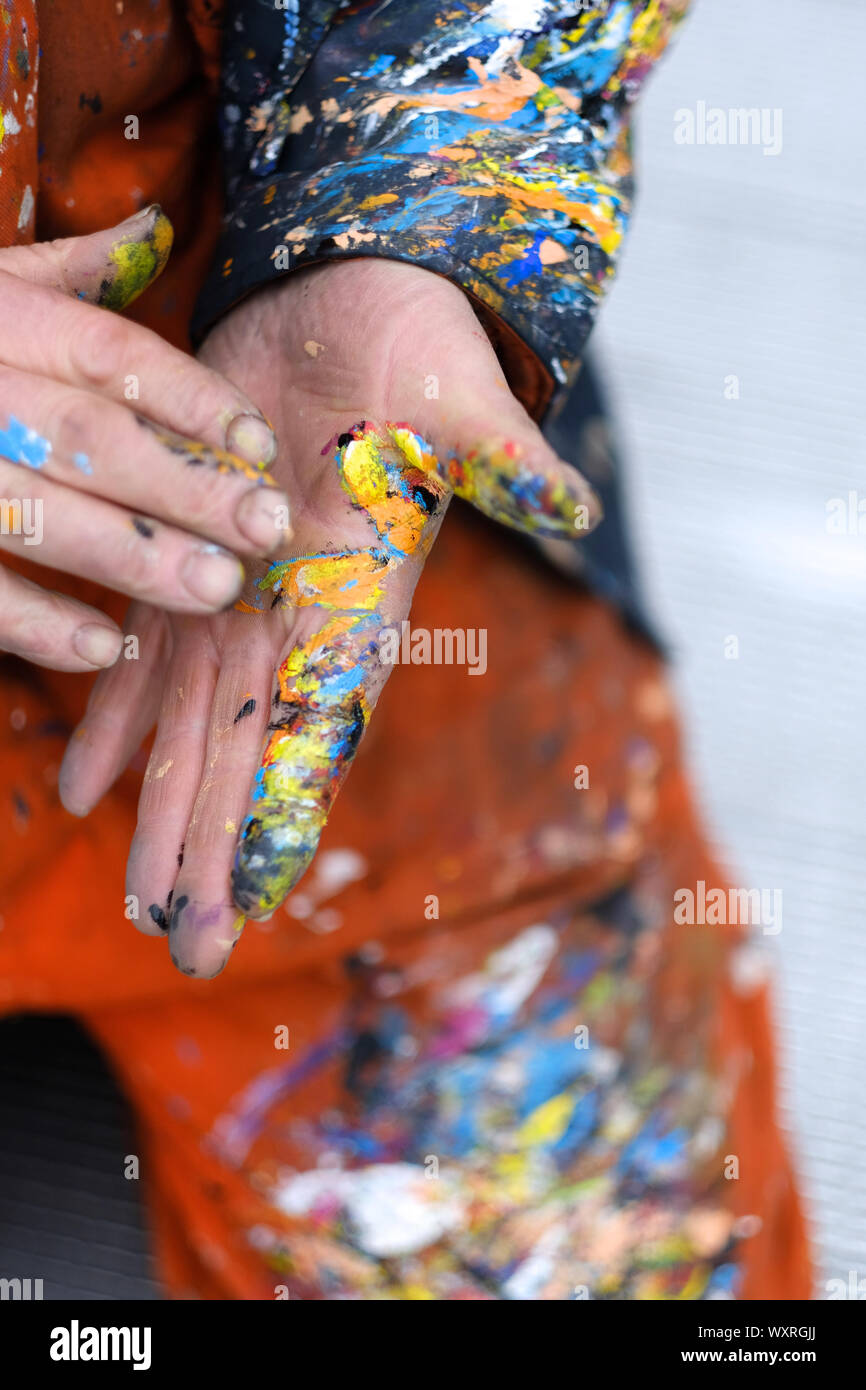 Hands of an artist who used to work many colors of paint Stock Photo ...