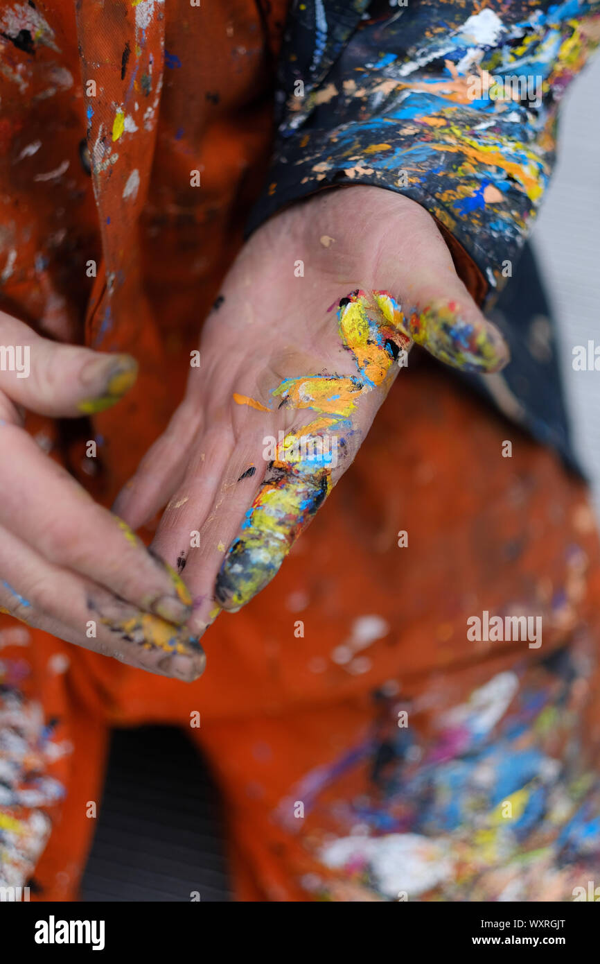 The hands of artist who have used a variety of colors and shades Stock ...