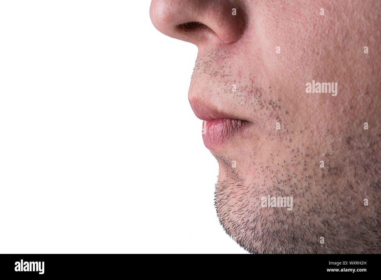 Unshaved young caucasian man's face profile isolated on white ...
