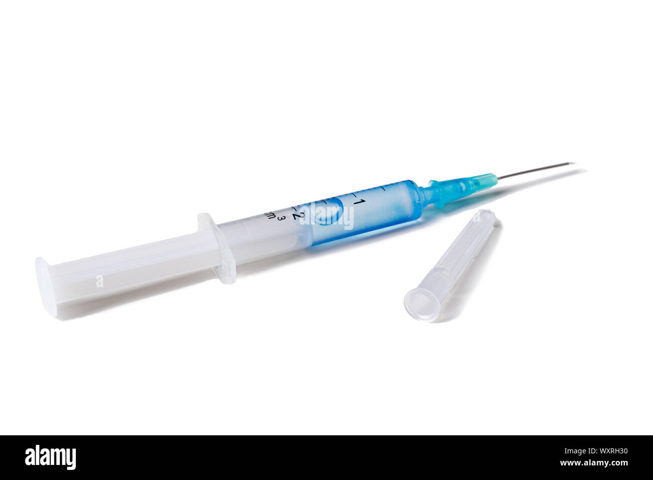 Syringe with blue liquid and a needle isolated on white background with ...