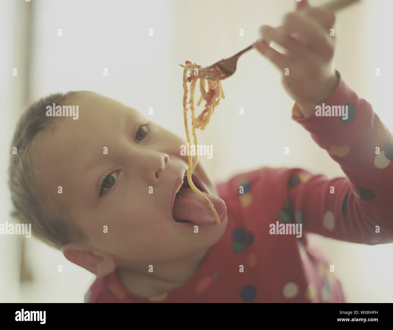 Boy eating pasta Stock Photo - Alamy