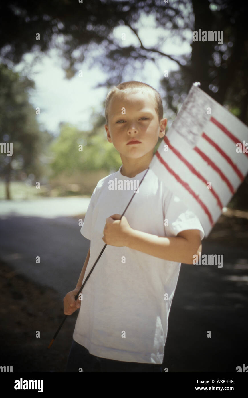 Young boy carrying flag hi-res stock photography and images - Alamy