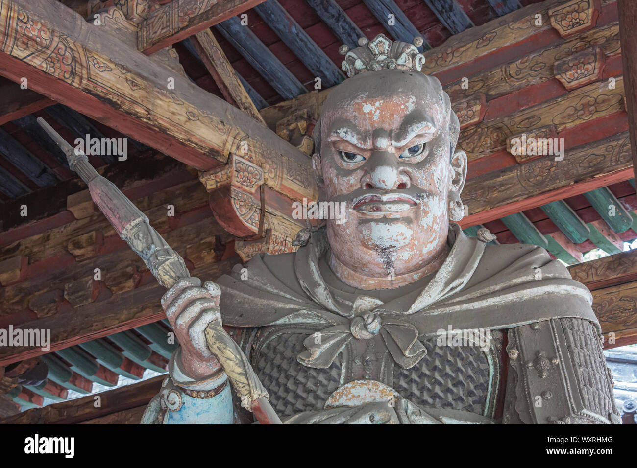 Facing a giant wooden statue in the Goddess Mother Hall in the Jinci ...