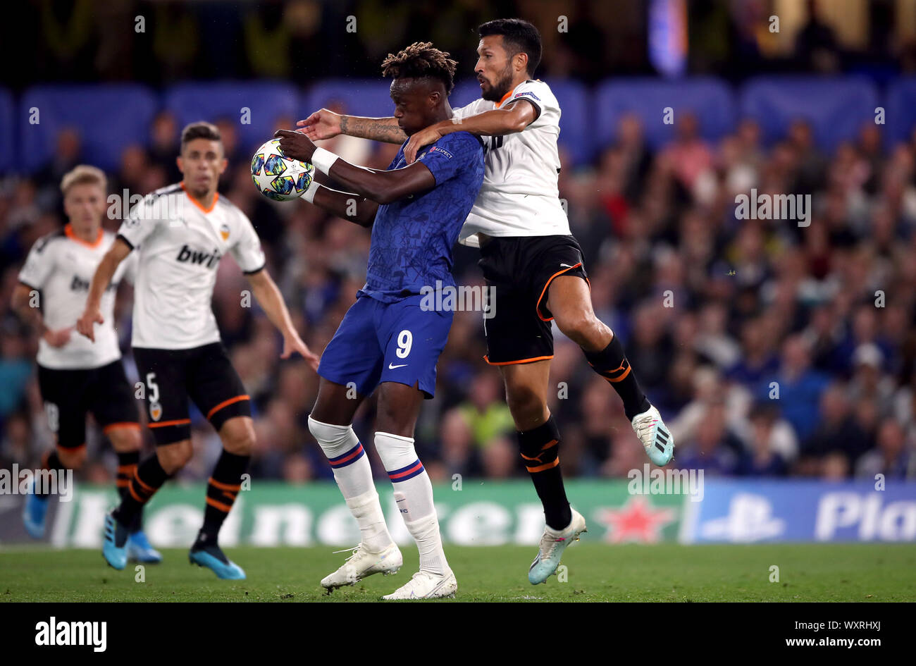 Chelsea's Tammy Abraham (left) and Valencia’s Ezequiel Garay battle for ...
