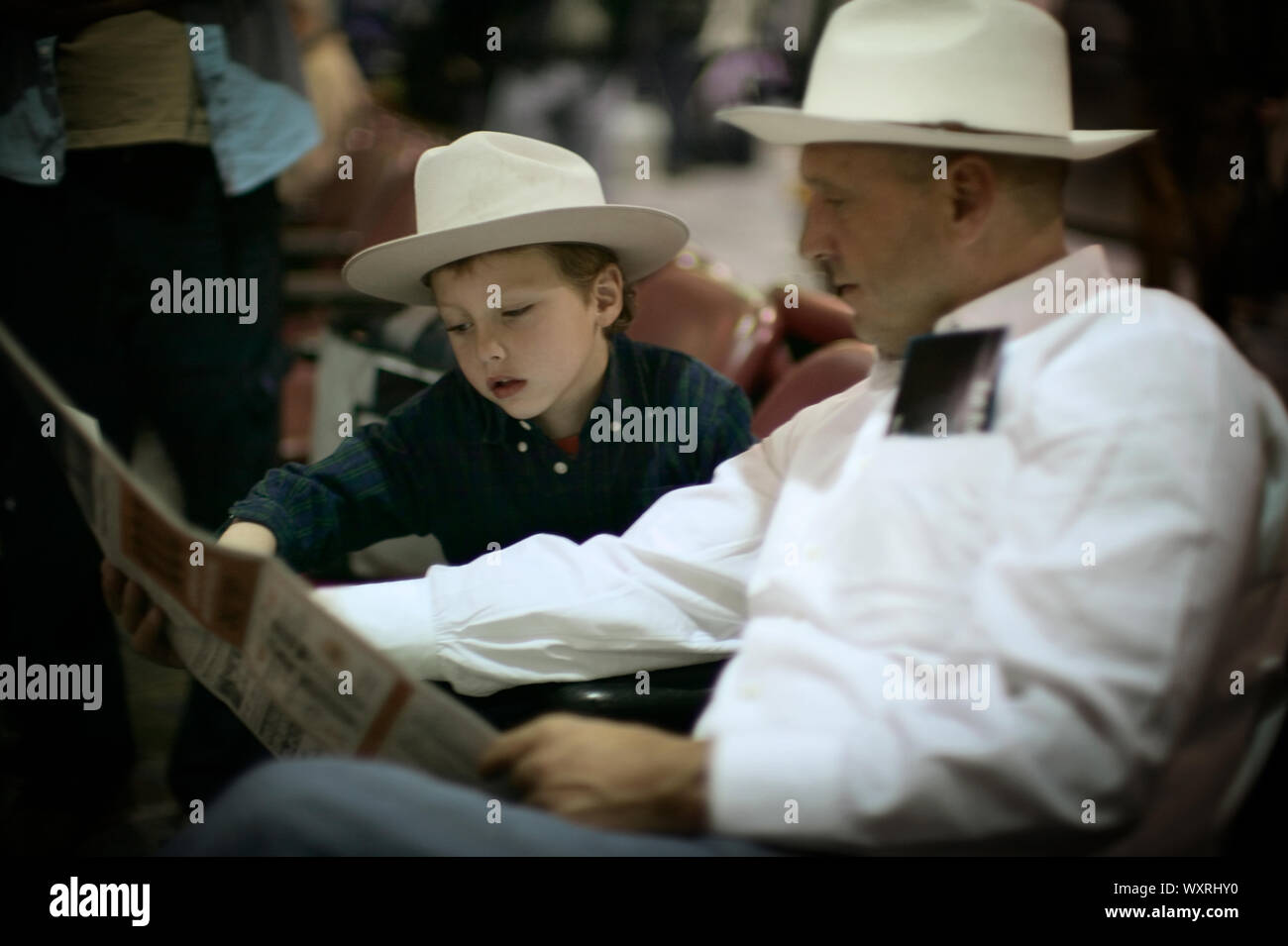 Father and son reading newspaper at airport Stock Photo - Alamy