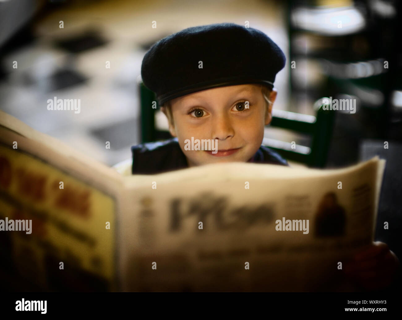 boy in beret reading the paper Stock Photo - Alamy