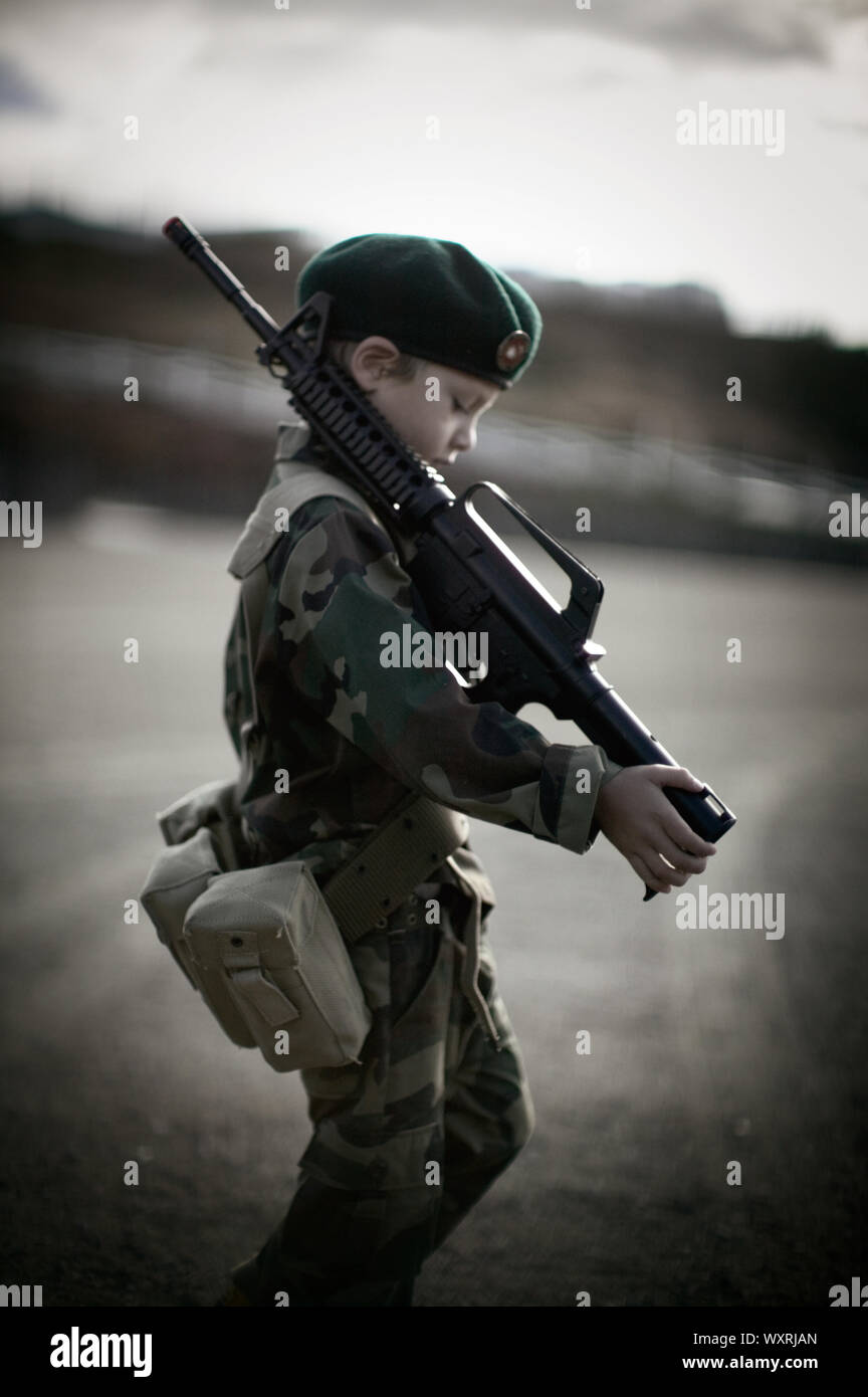 View of a small boy dressed in a military suit Stock Photo - Alamy
