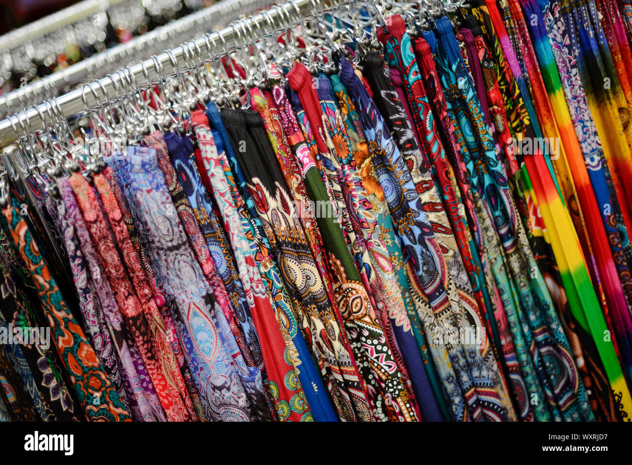 Colorful fashion clothing wear textiles on retail market stall display ...