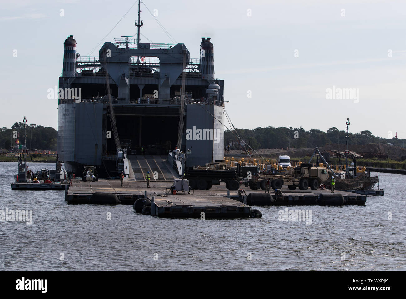 U.S. Army Soldiers prepare to unload vehicles and equipment from ...