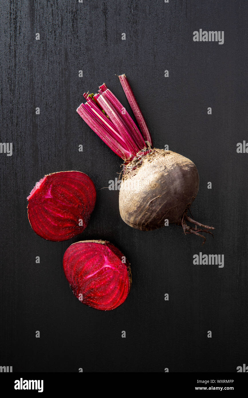 Tasty raw beetroot. Sliced beetroot on black kitchen table. Top view Stock Photo - Alamy