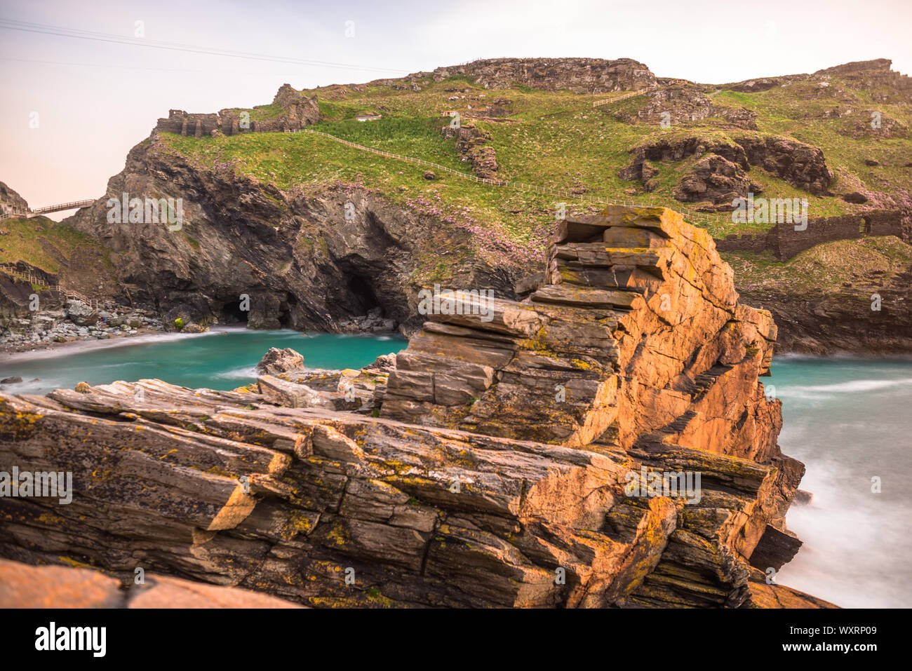 The ruins of Tintagel Castle on Tintagel Island at sunset, a site ...