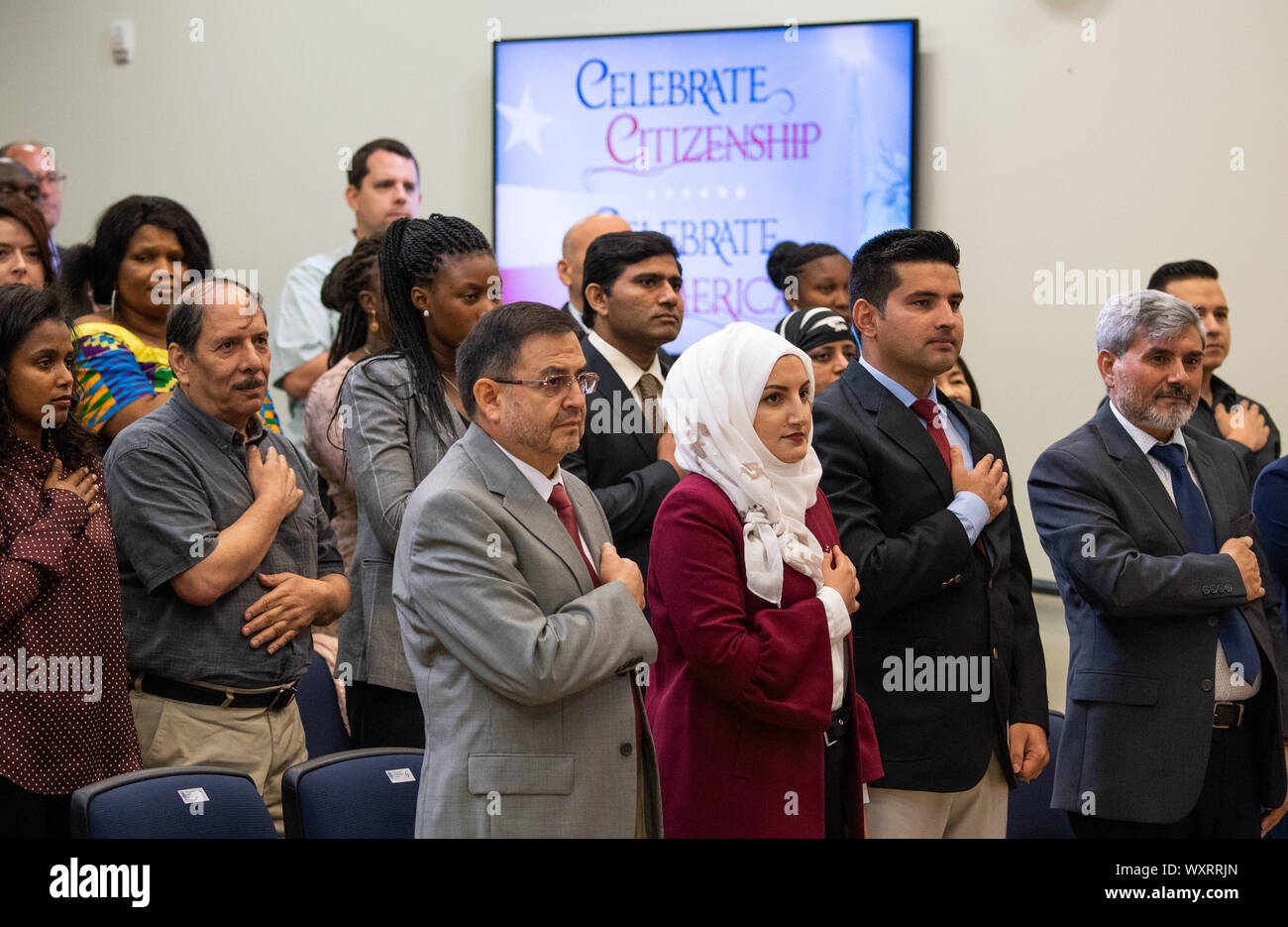 People take the oath of citizenship during a White House naturalization ...