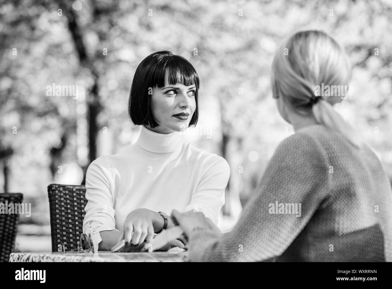 Two girls chatting Black and White Stock Photos & Images - Alamy