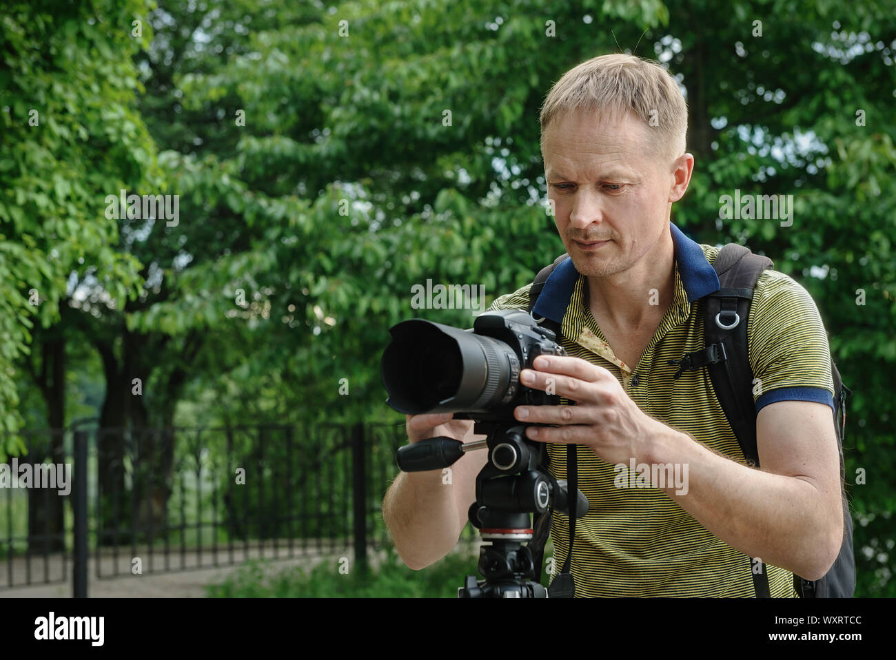 He is adjusting the camera Stock Photo - Alamy