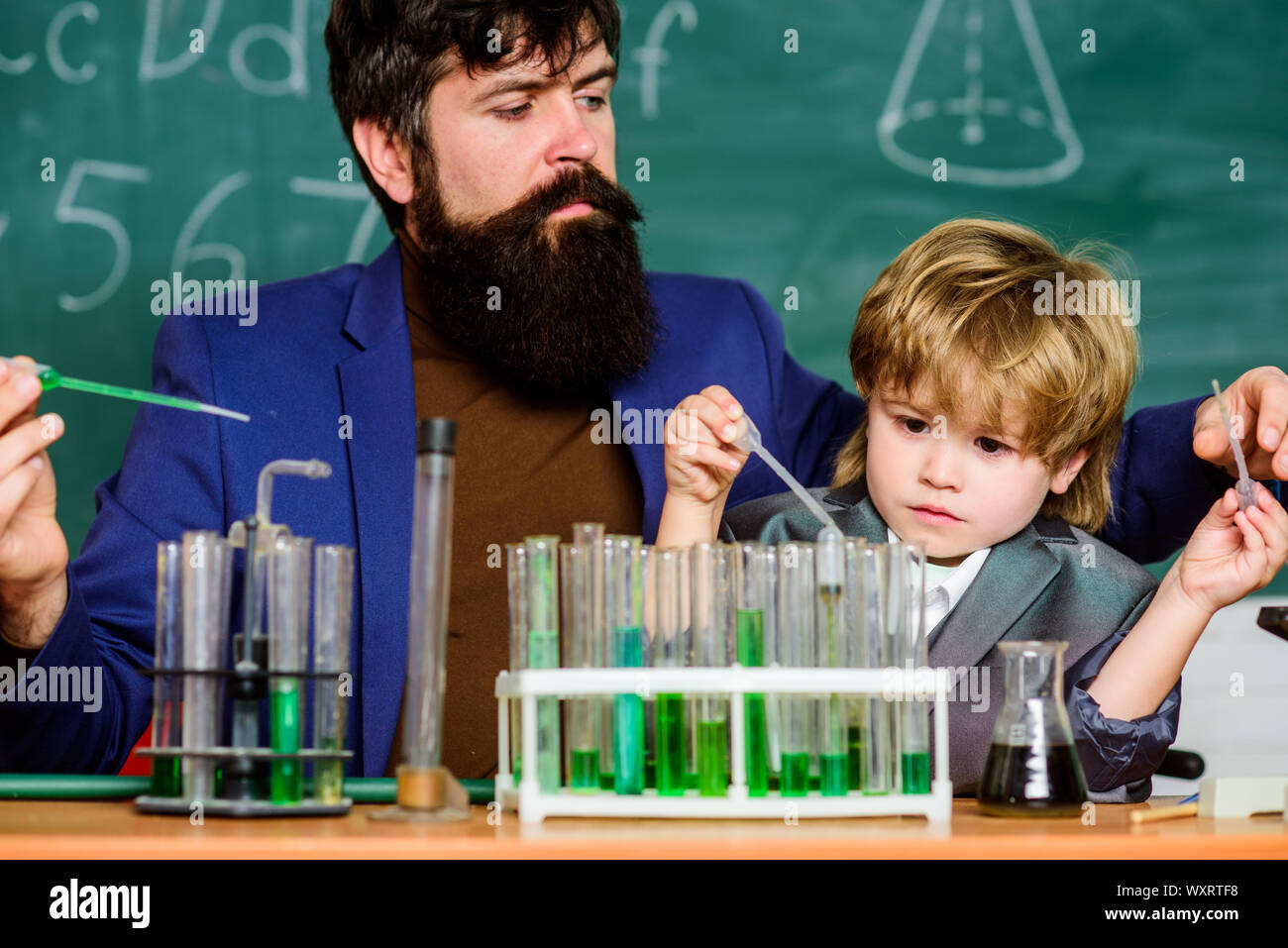 father and son at school. Back to school. Little kid learning chemistry ...