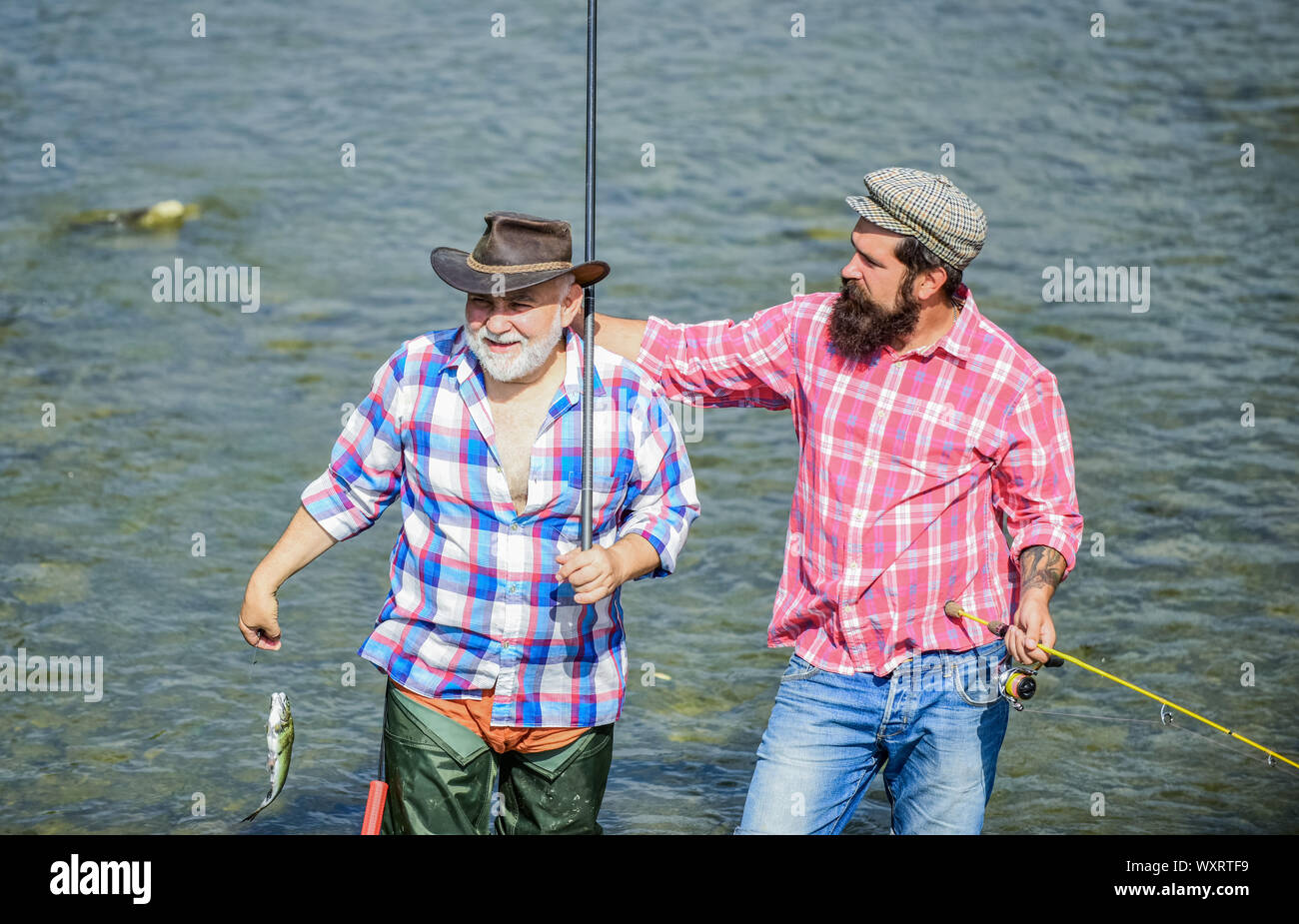Male friendship. Men stand in water. Nice catch concept. Fishing team ...