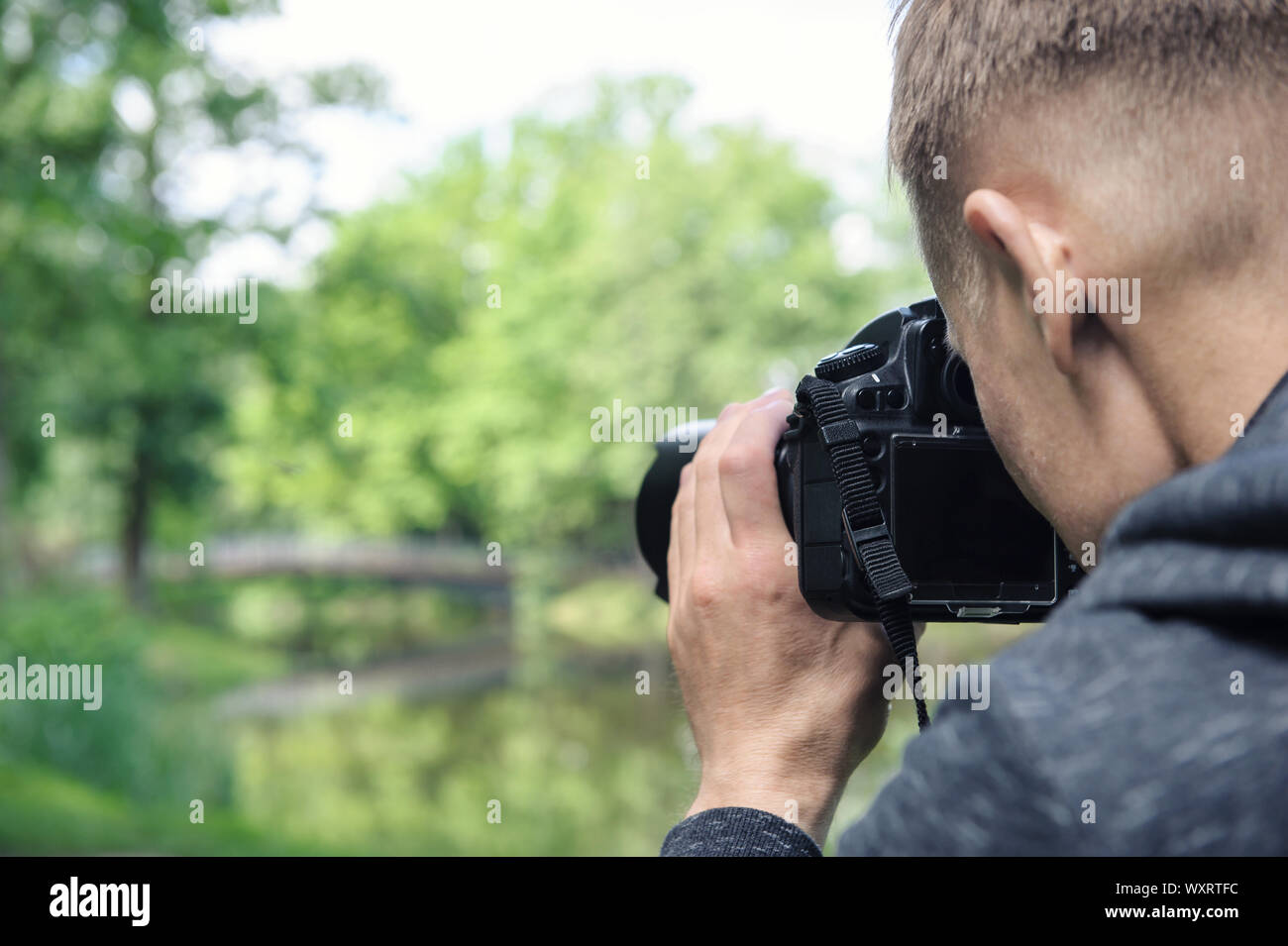 The photographer is photographing with the camera. He is focusing on ...