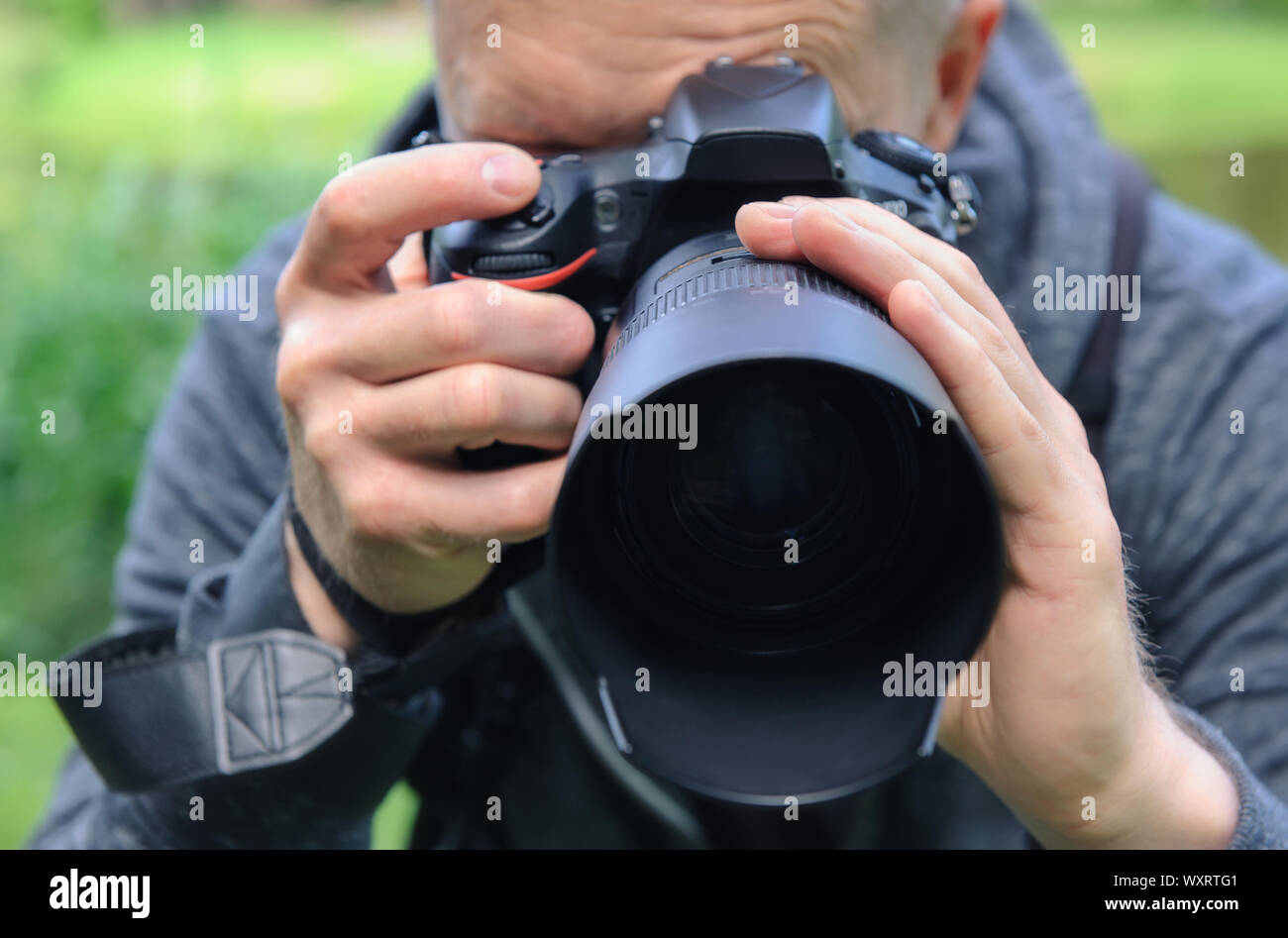 The photographer is photographing with the camera. He is focusing on ...