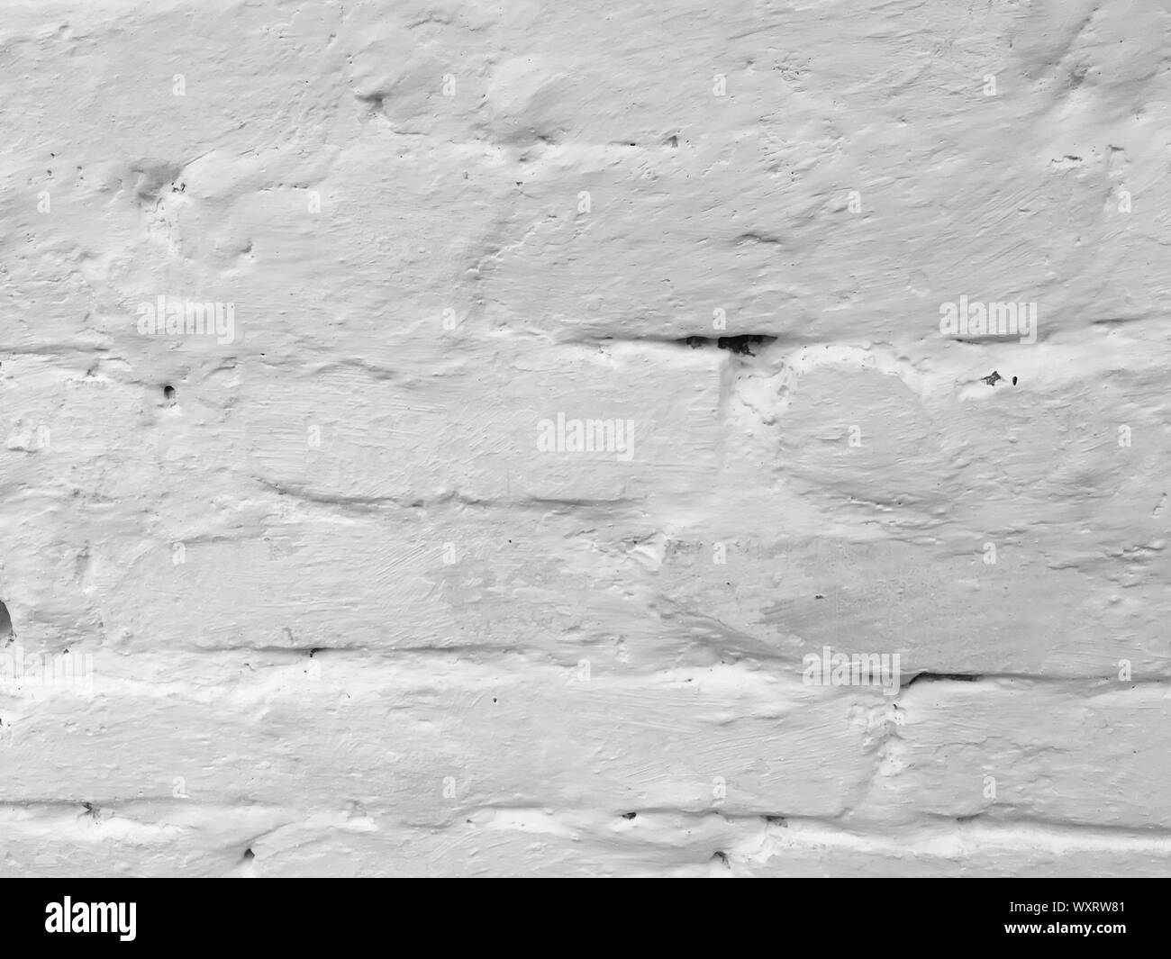 Brick red old wall covered with white paint. Bricks pattern. Close-up ...