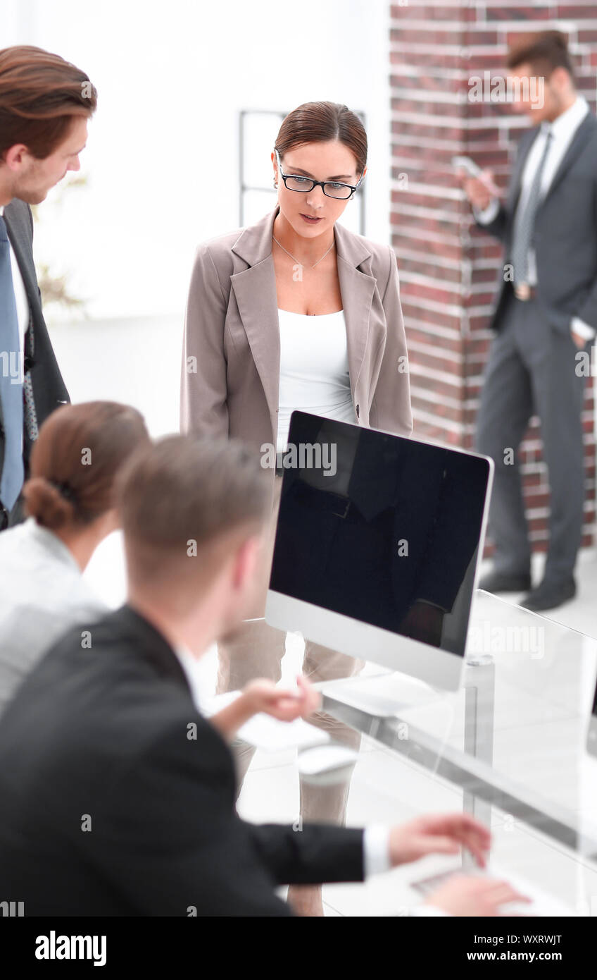 business team sitting at the office Desk Stock Photo - Alamy