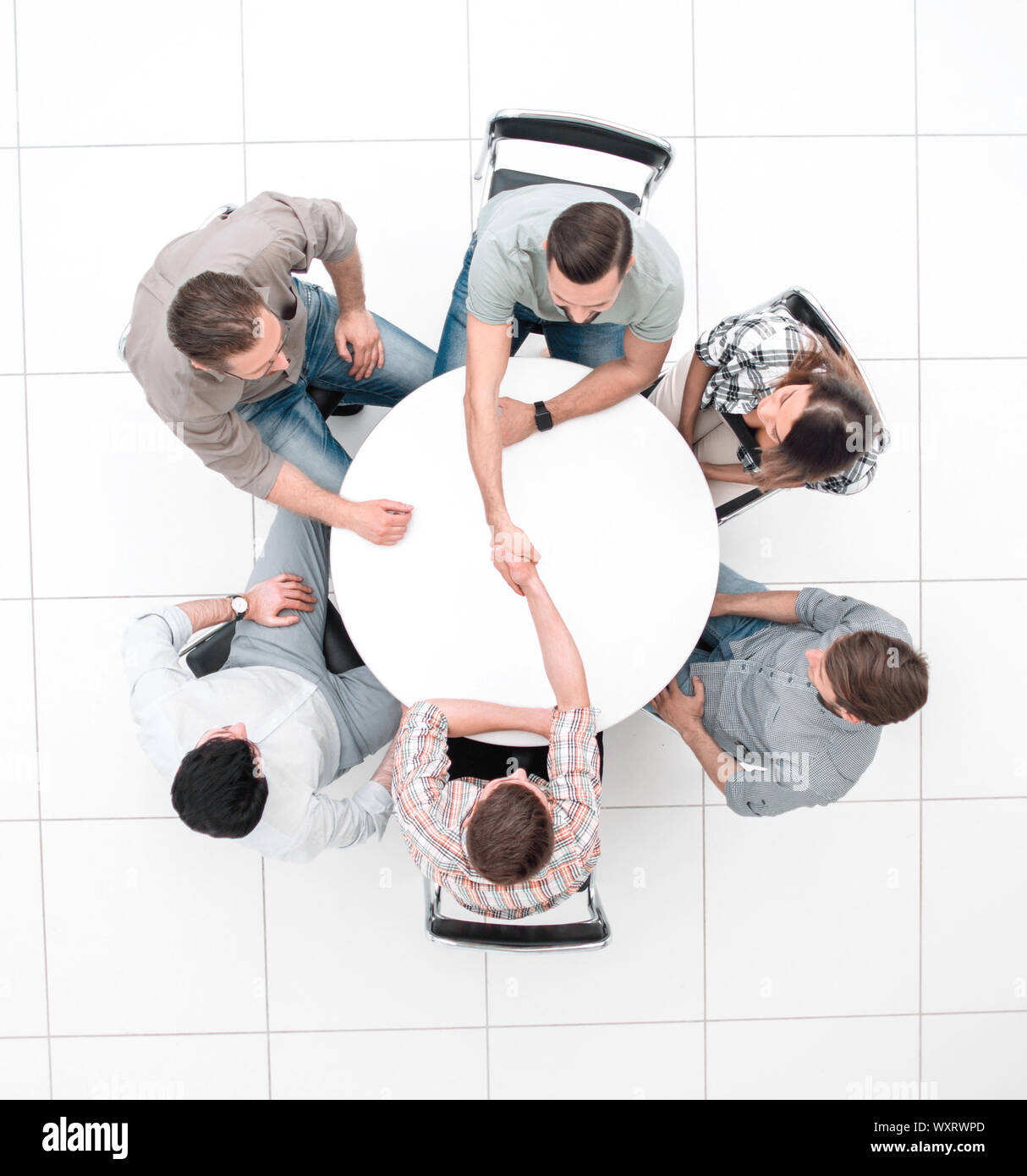 top view. handshake colleagues at the round table Stock Photo - Alamy