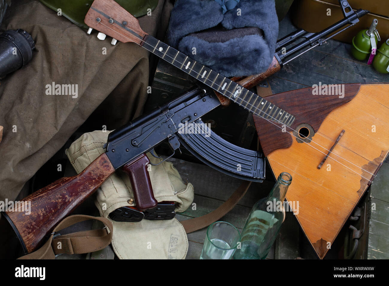 Kalashnikov AK 47 with ammunitions, vodka and balalaika on army green ...