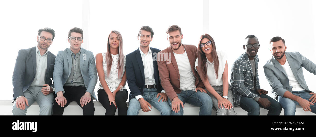 young people are waiting for an interview, sitting in the office lobby ...