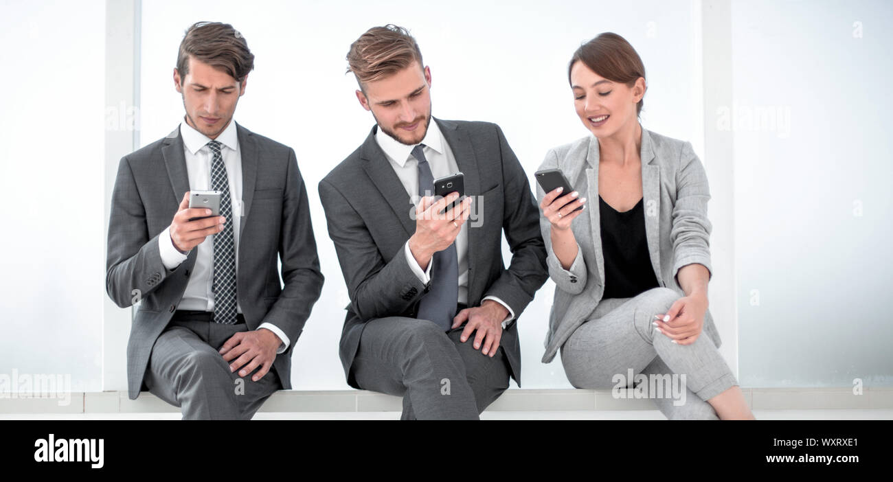 business team using their smartphones during work break Stock Photo - Alamy