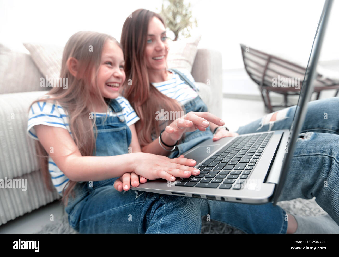 happy mother with adorable little girl with laptop Stock Photo - Alamy