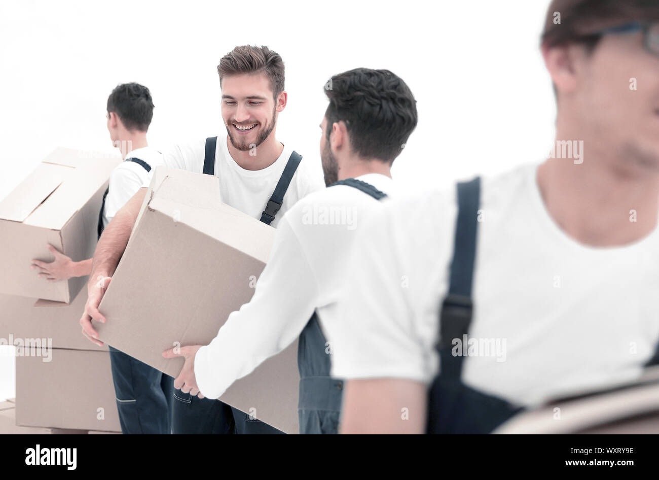 Photo workers pass each other boxes when moving flats Stock Photo - Alamy