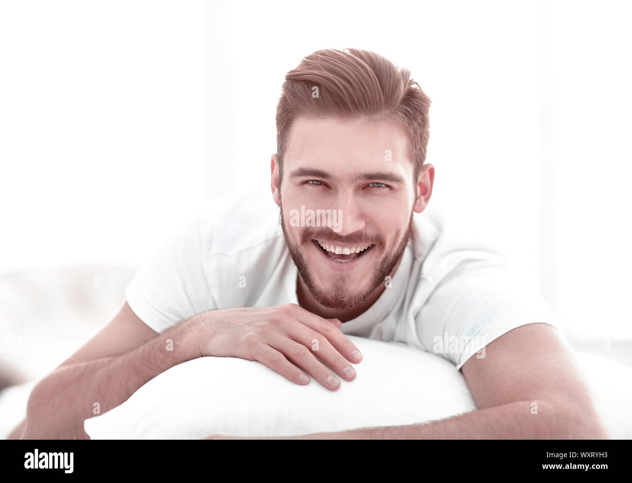 closeup.smiling man lying on the sofa Stock Photo - Alamy