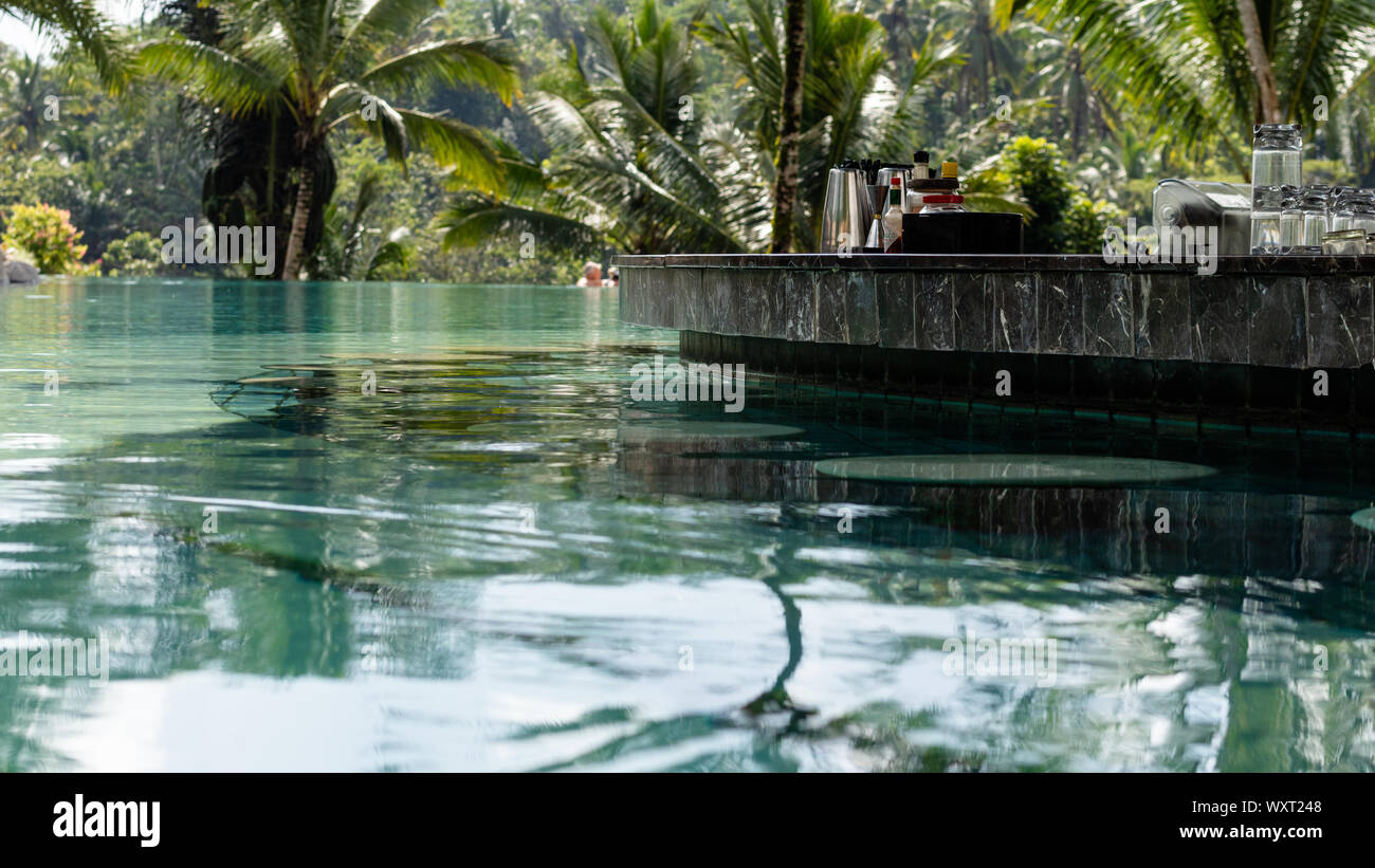A luxury infinity pool in a tropical resort Stock Photo - Alamy