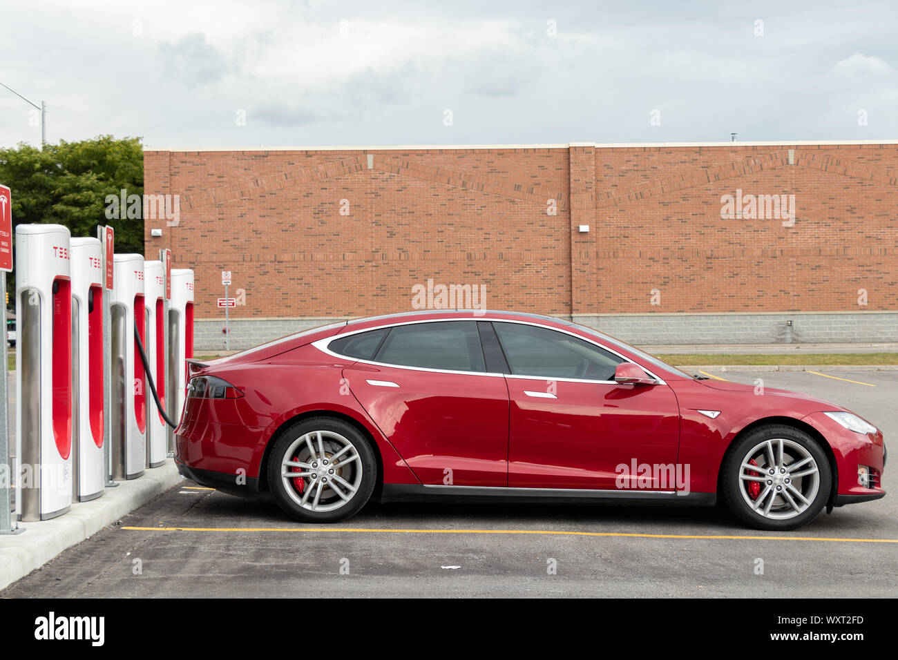 Side of Tesla Model S while plugged-in and charging at Supercharger ...