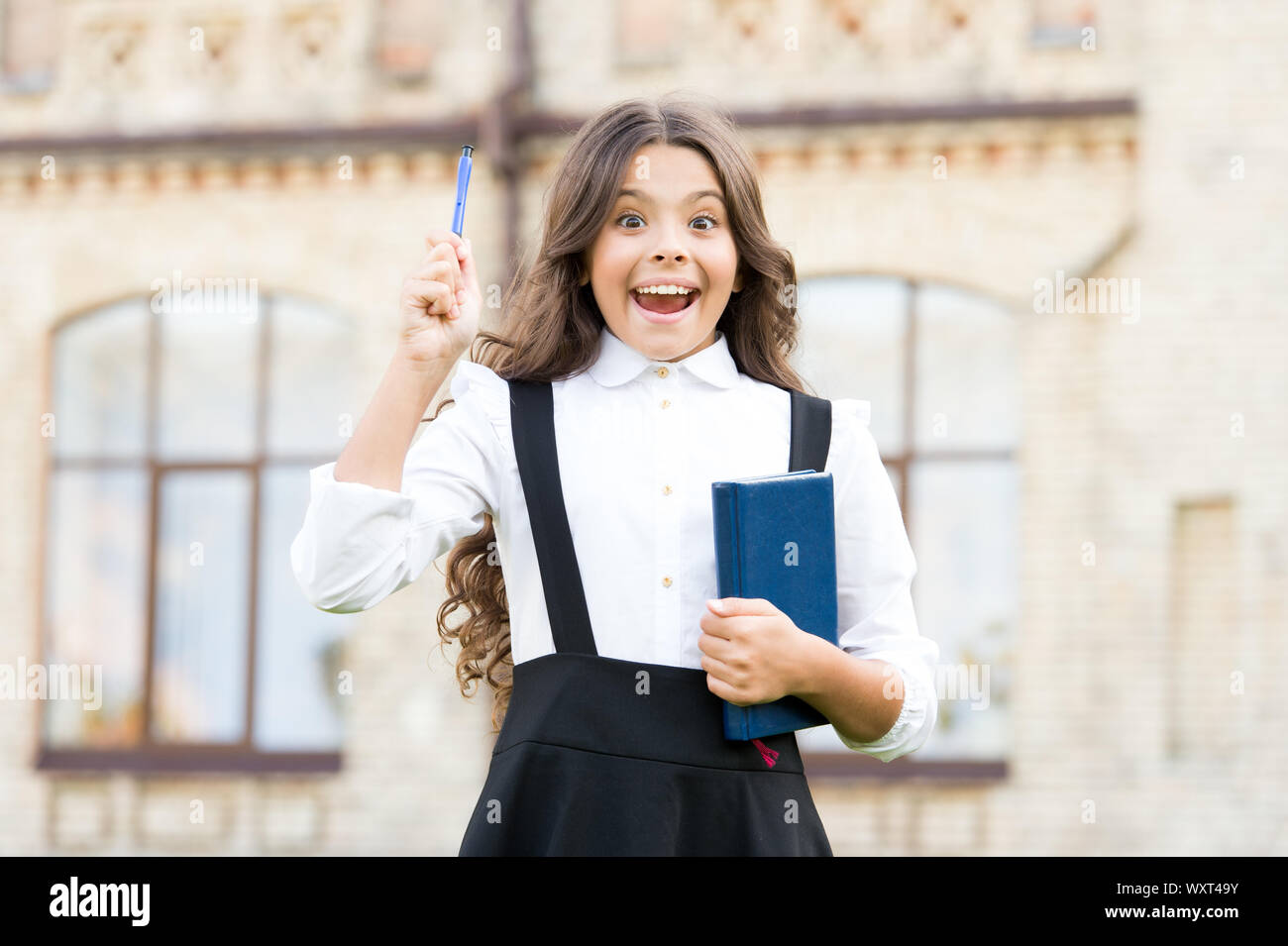 Welcome back to school. School girl formal uniform hold book. Towards ...