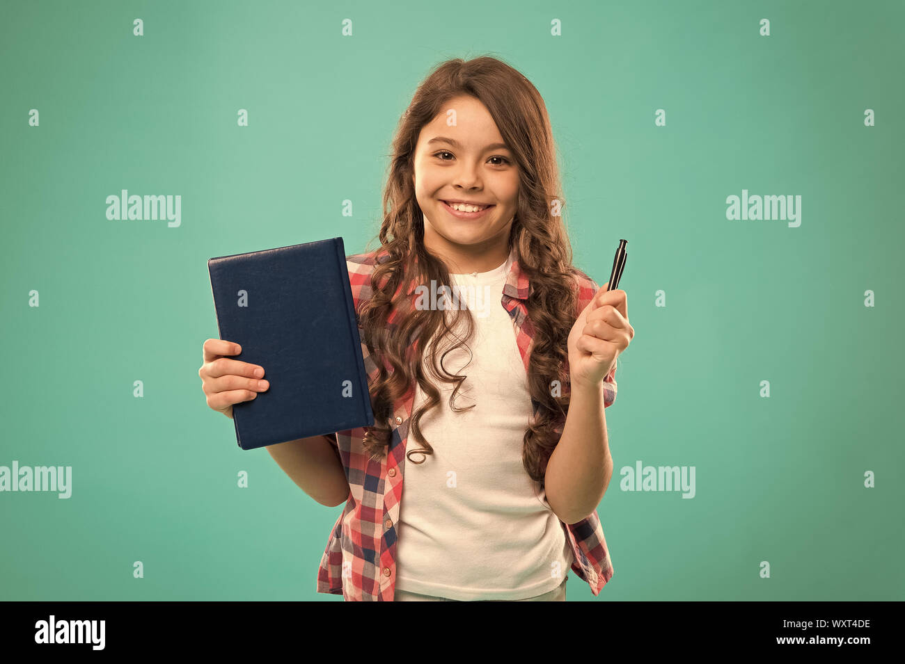 I am ready for school. Child smart kid hold pen and notepad. Girl cute ...