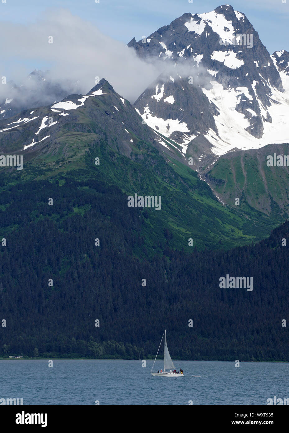 SAILBOAT BY THE SNOW COVERED MOUNTAIN AT SEWARD ALASKA Stock Photo - Alamy